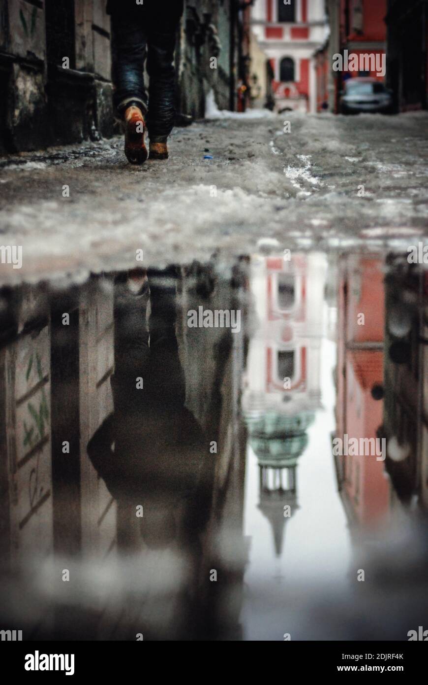 Puddle on alley street hi-res stock photography and images - Alamy