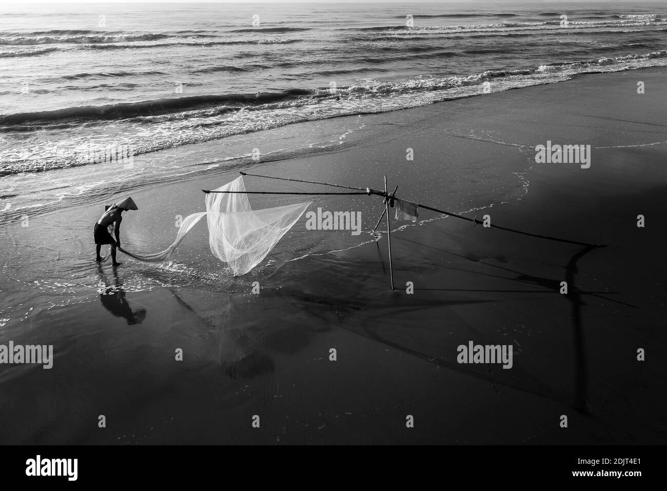 Fisherman Working With Net At Beach Stock Photo - Alamy