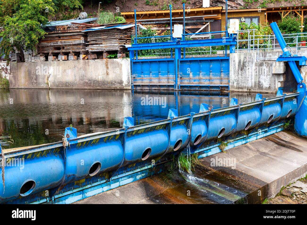 blue metal dam on a small river in the village Stock Photo - Alamy