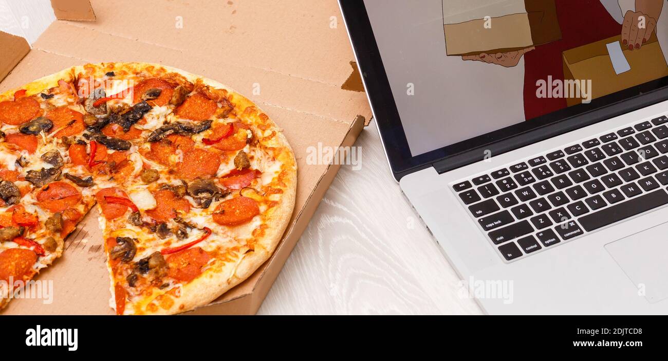 food order concept. Close-up top view of a ordering pizza with a laptop ...
