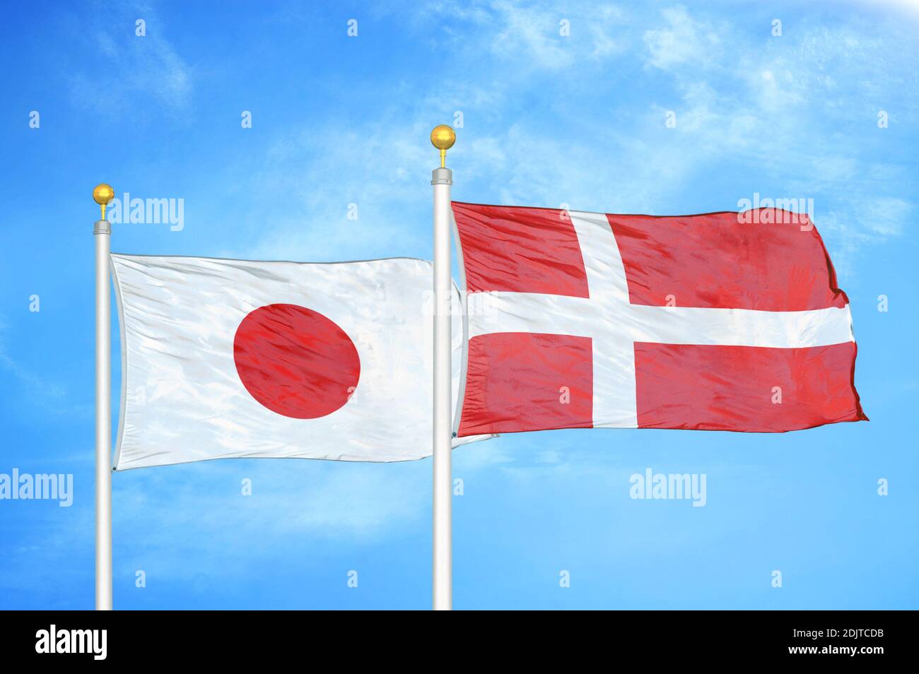 Japan and Denmark two flags on flagpoles and blue cloudy sky Stock ...