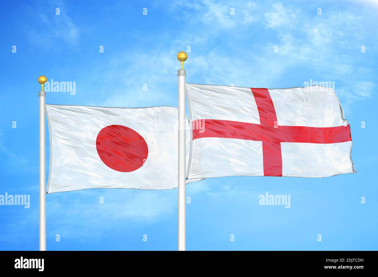 Japan and England two flags on flagpoles and blue cloudy sky Stock ...