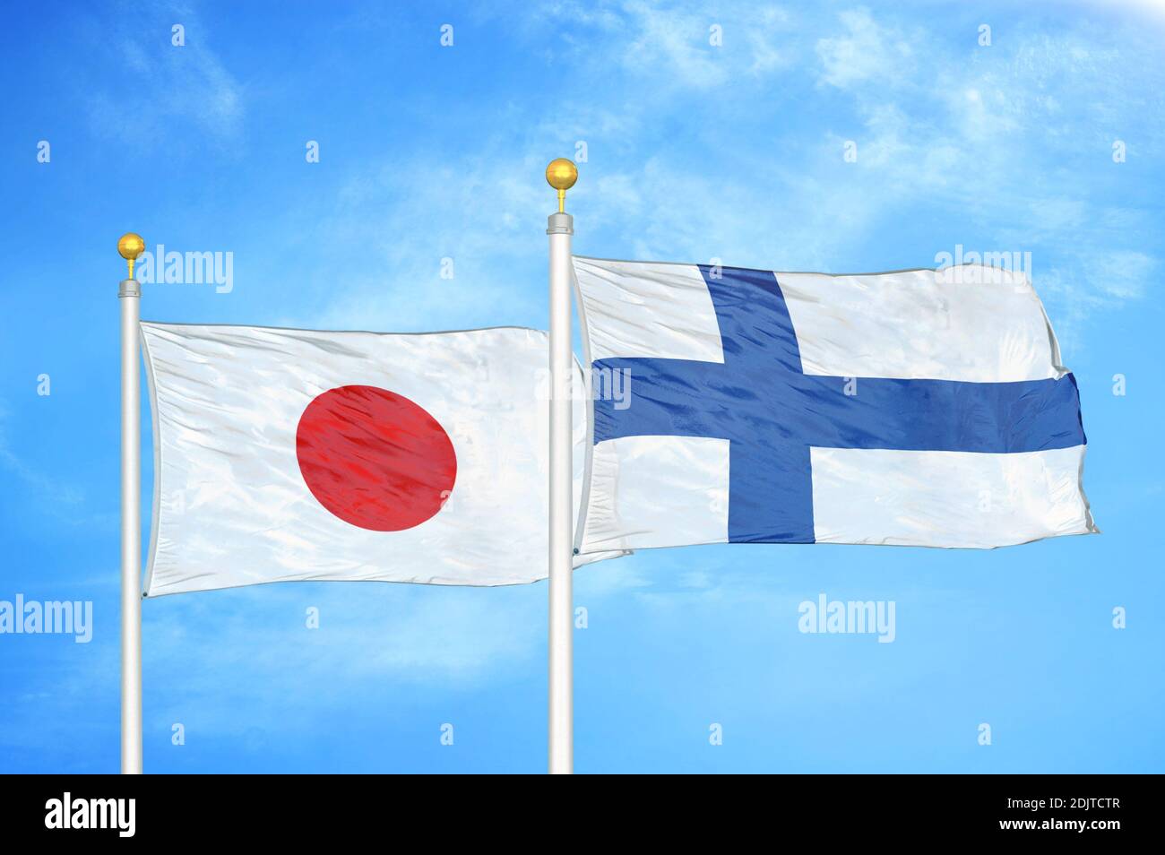 Japan and Finland two flags on flagpoles and blue cloudy sky Stock ...