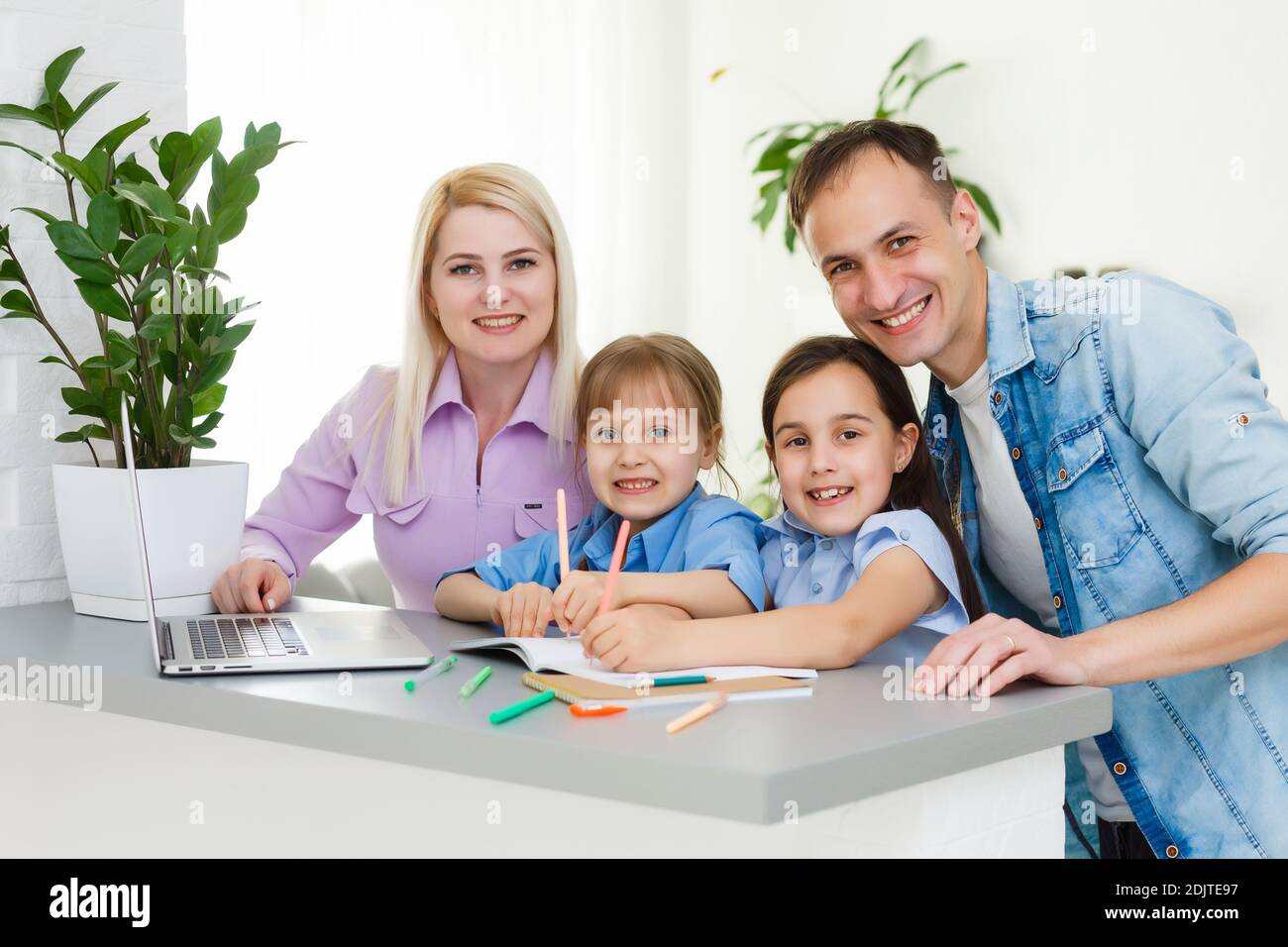 Family using the internet in the kitchen together Stock Photo - Alamy
