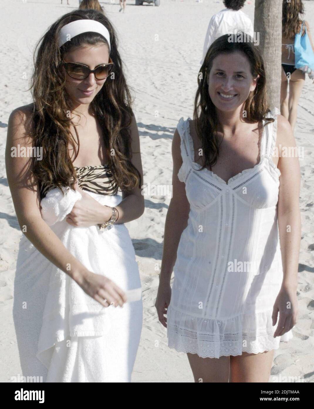 Sopranos actress Jamie-Lynn DiScala covers up her bikini as she strolls ...