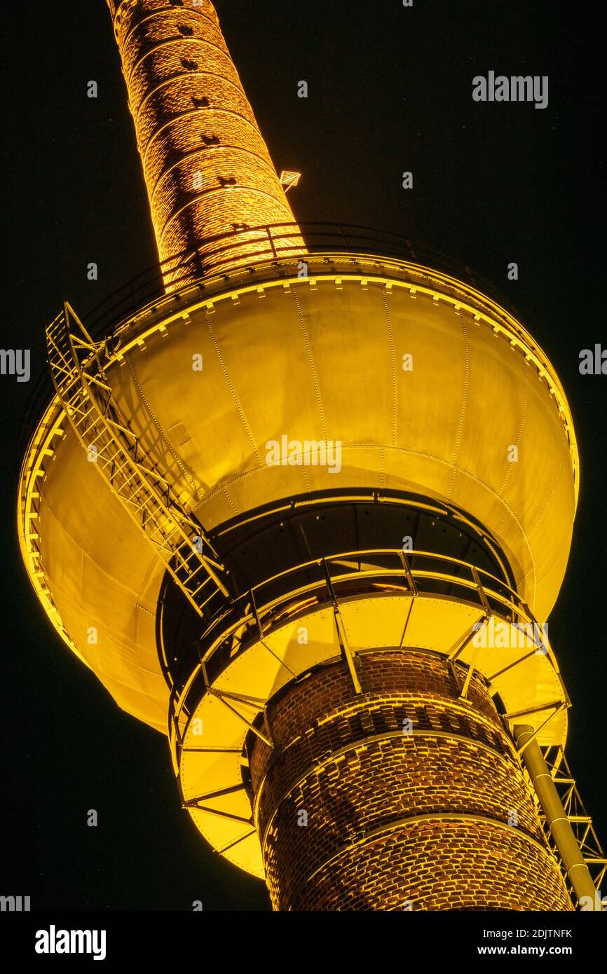 Old brick factory chimney illuminated with golden light at night Stock ...