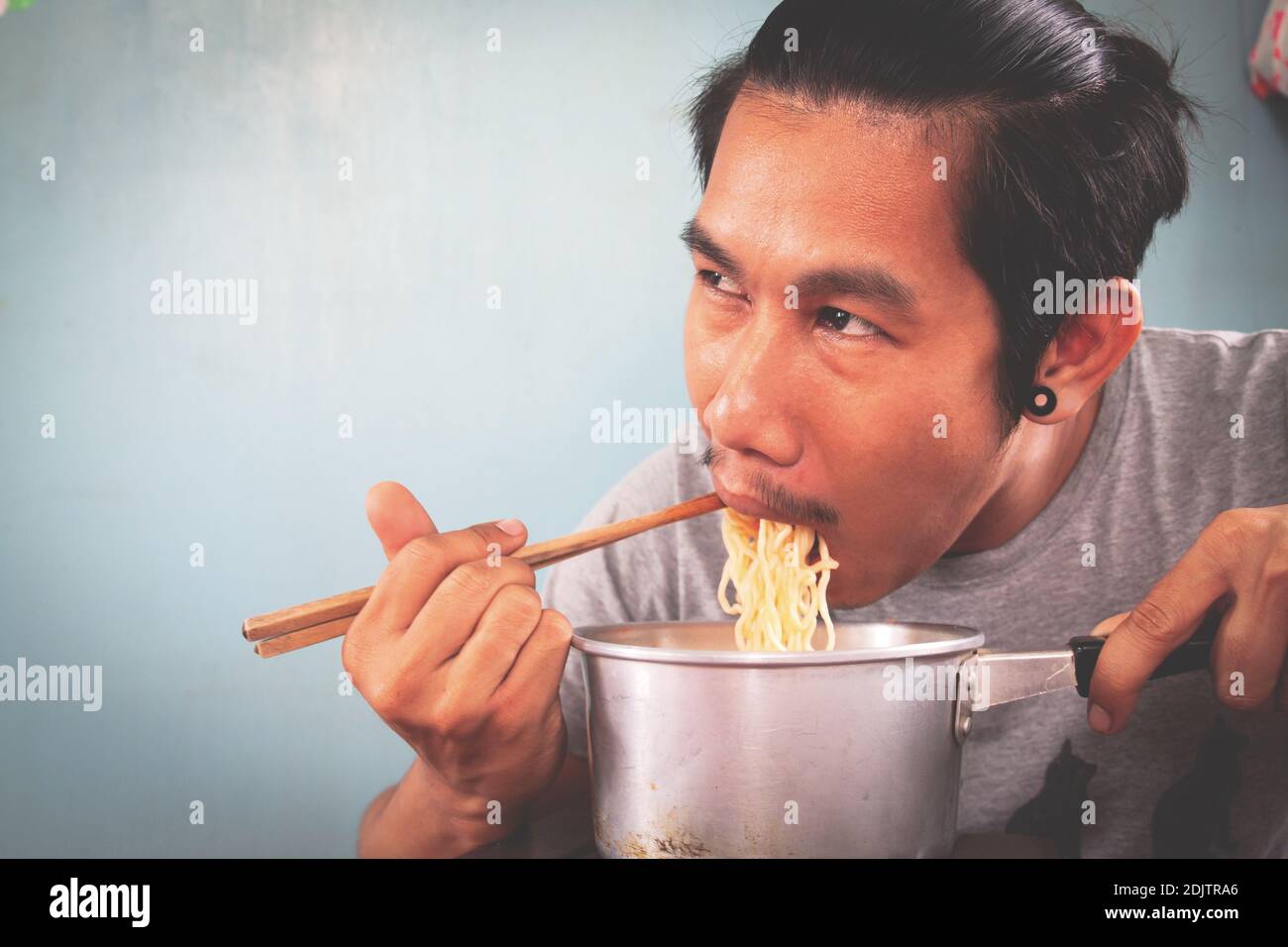 Indian man eating noodles hi-res stock photography and images - Alamy