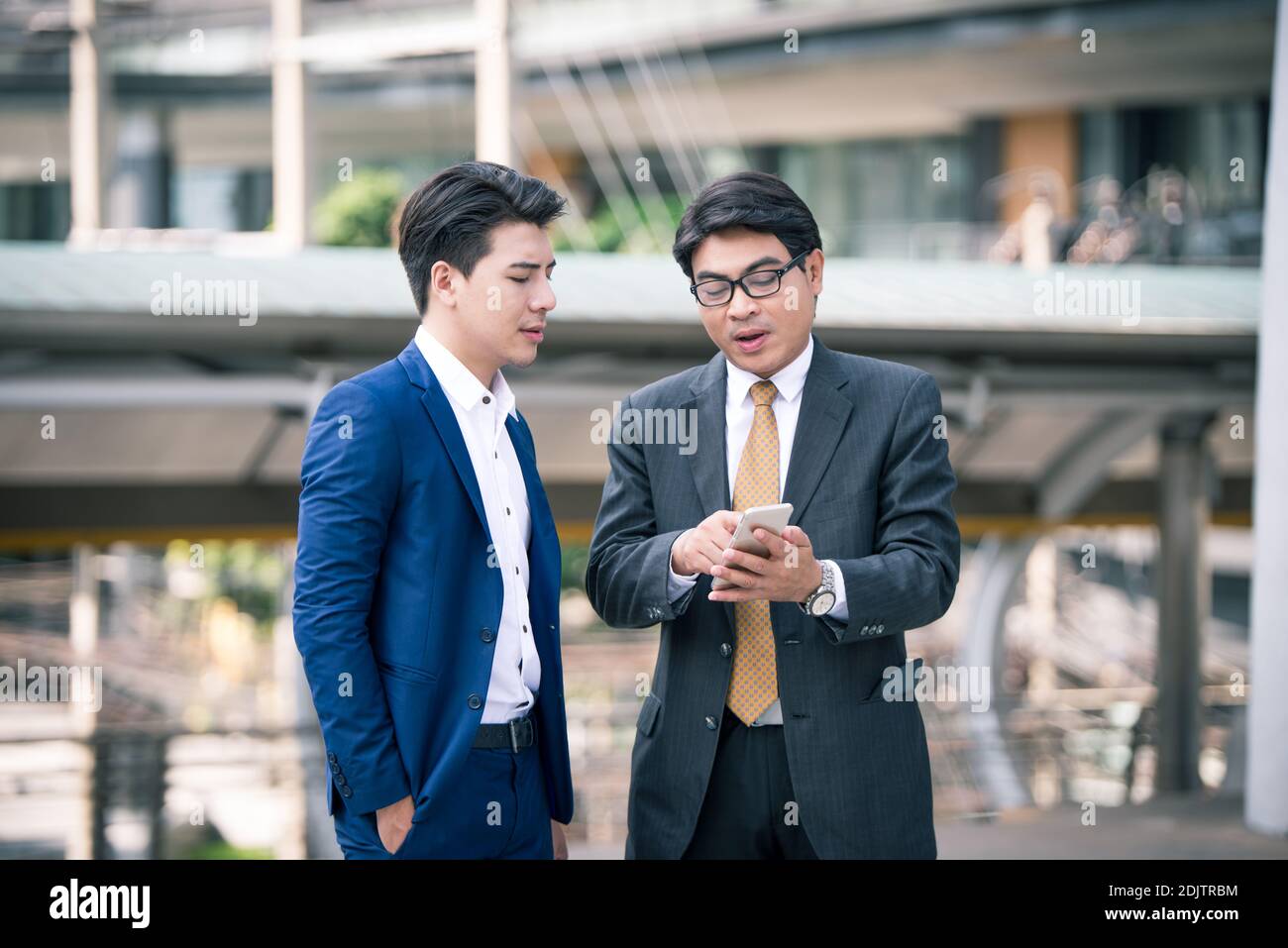 Businessmen Using Phones At Roadside Stock Photo - Alamy