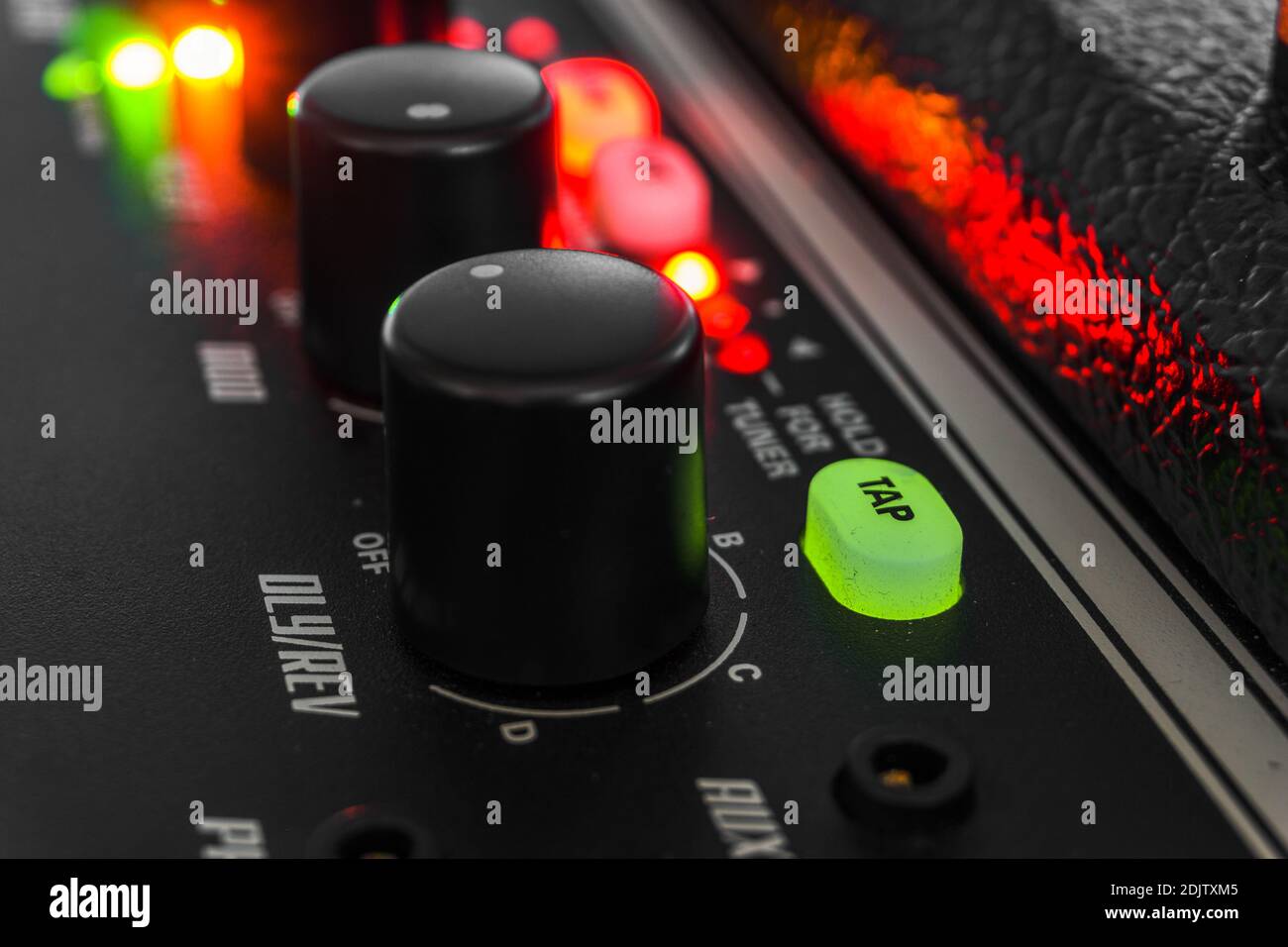 Detail of an amplifier for electric guitar with green and red lights ...