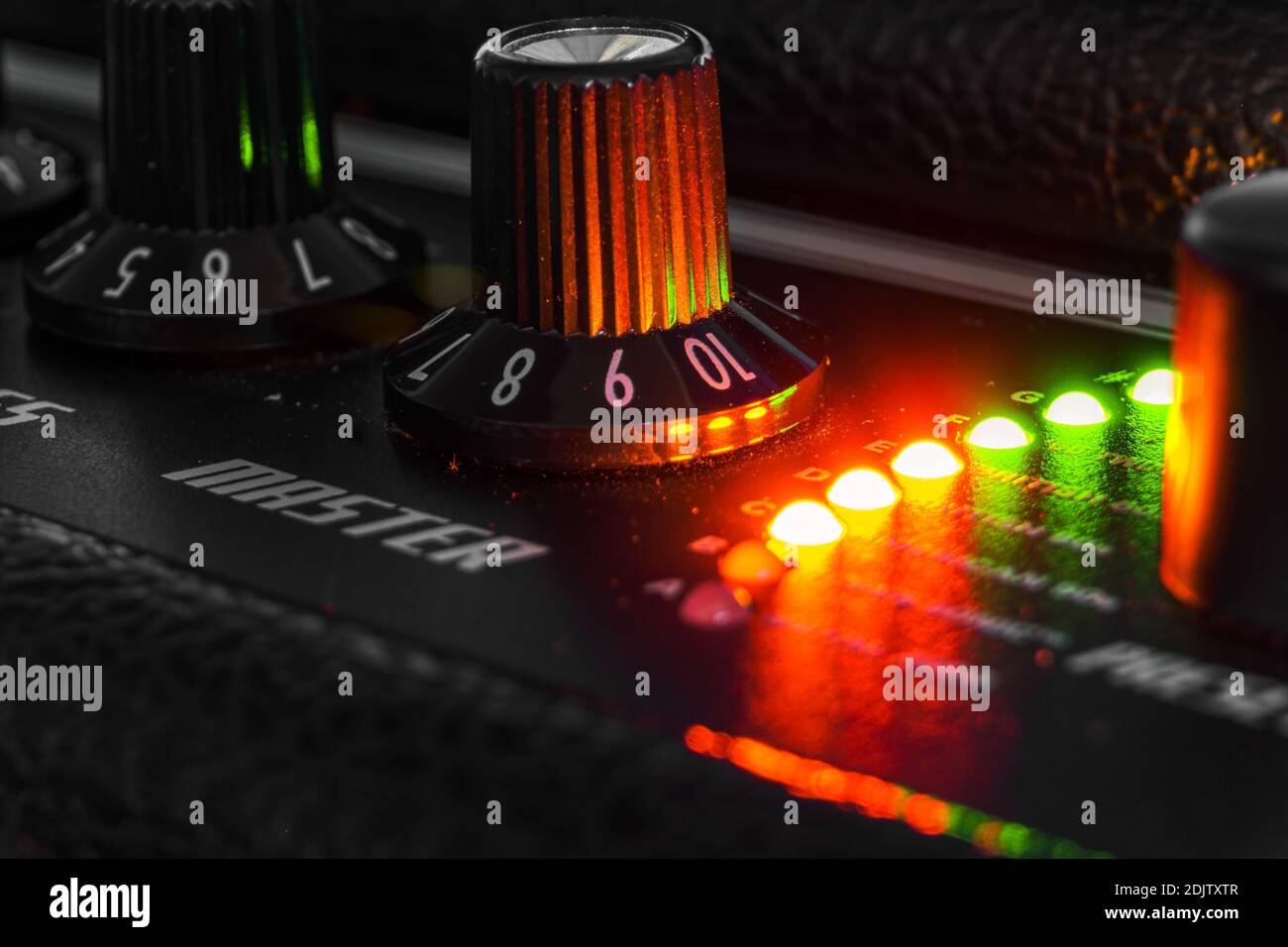 Detail of an amplifier for electric guitar with green and red lights ...