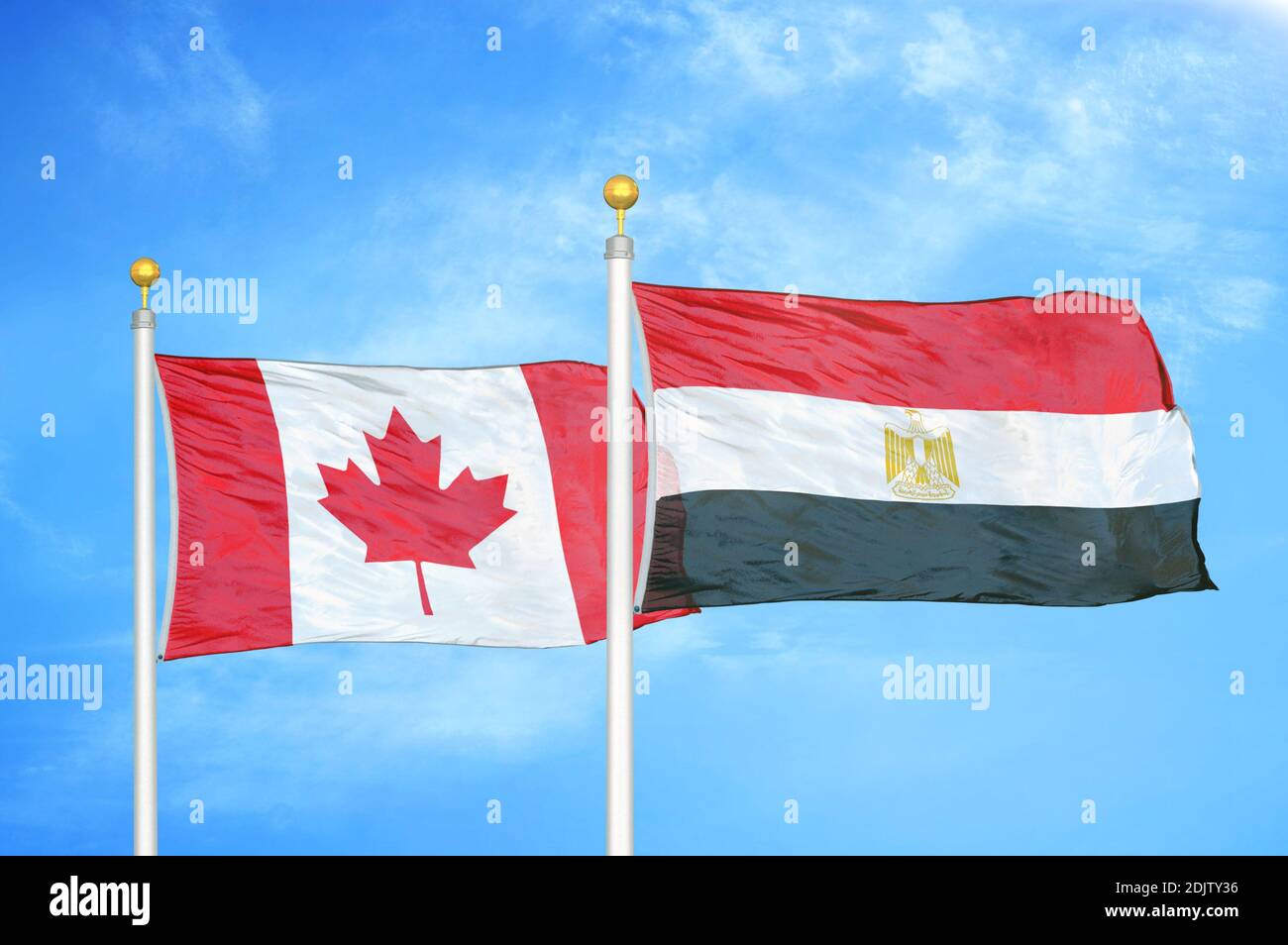 Canada and Egypt two flags on flagpoles and blue cloudy sky Stock Photo ...