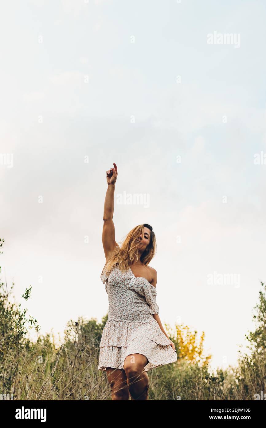 Beautiful Woman Outdoors Raised Arm Smiling Stock Photo - Alamy