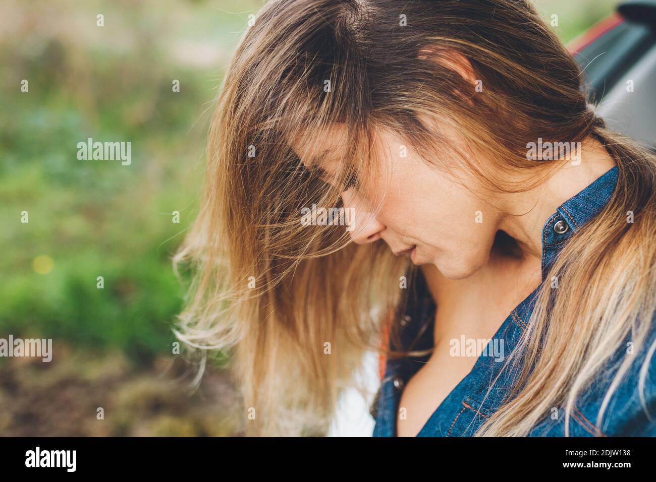 Beautiful Woman Looking Down Taken In Profile Stock Photo - Alamy