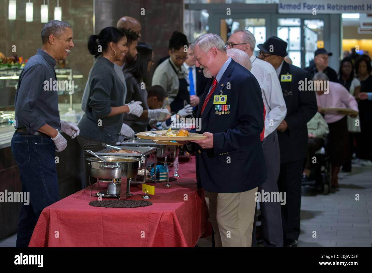 US President Barack Obama and First Lady Michelle Obama serve ...
