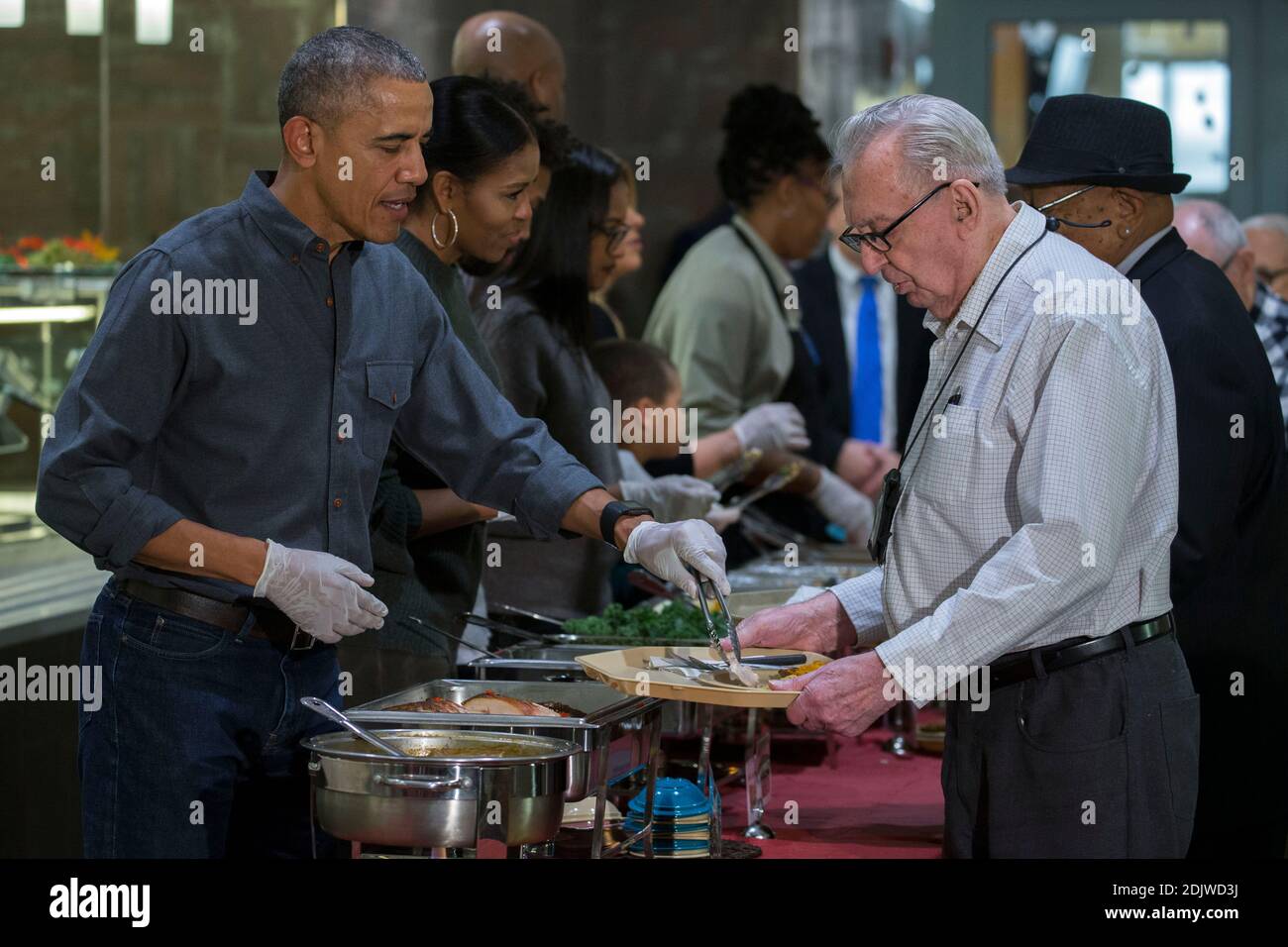 US President Barack Obama and First Lady Michelle Obama serve ...