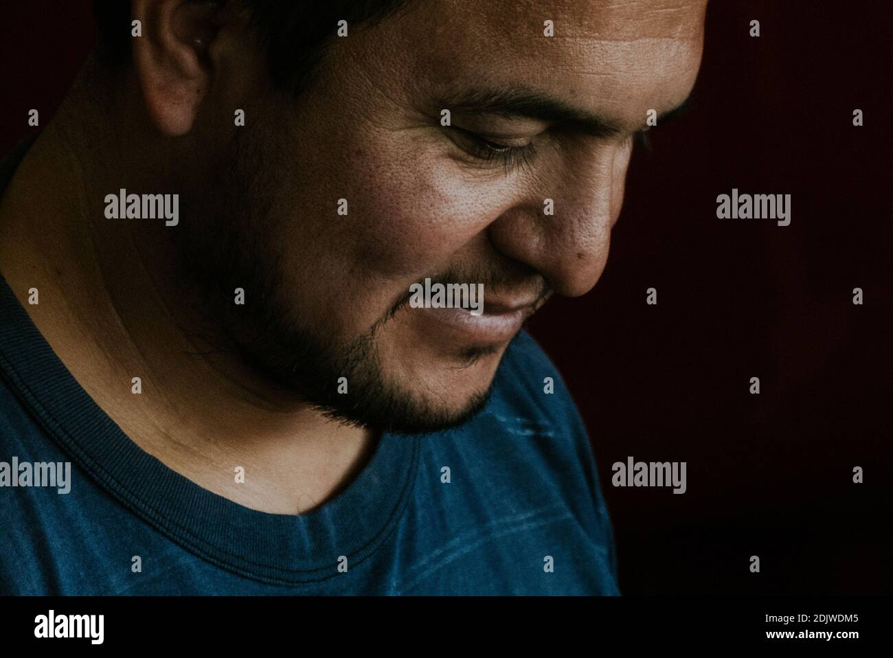 Close-up Of Sad Man Looking Down Against Black Background Stock Photo ...
