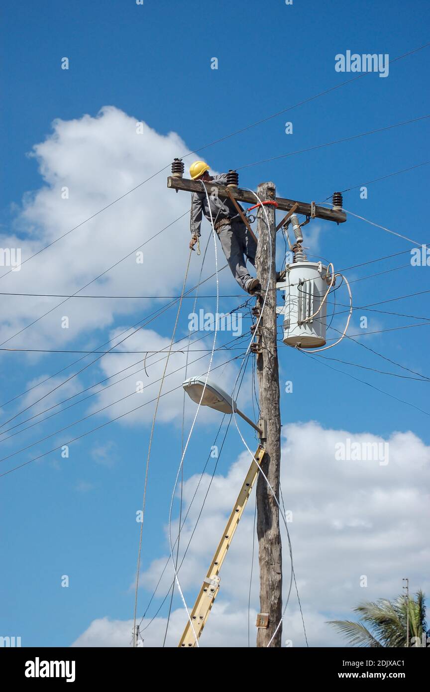 A vertical shot of electric lineman working on pole Stock Photo - Alamy