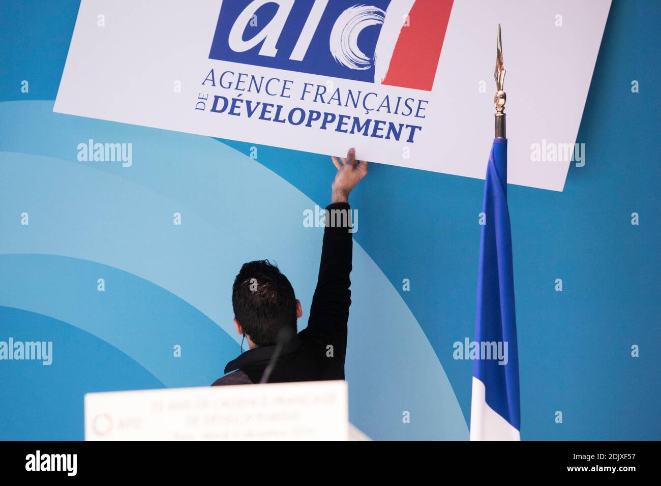 A man is taking the sign reading AFP of the wall during a ceremony for ...