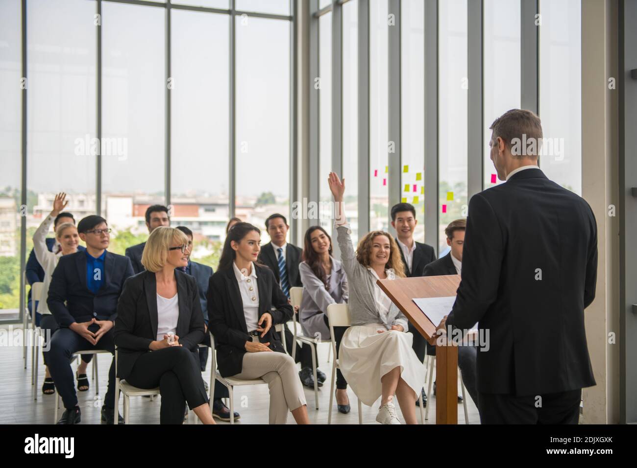 Sitting communication hand raised crowd hi-res stock photography and ...