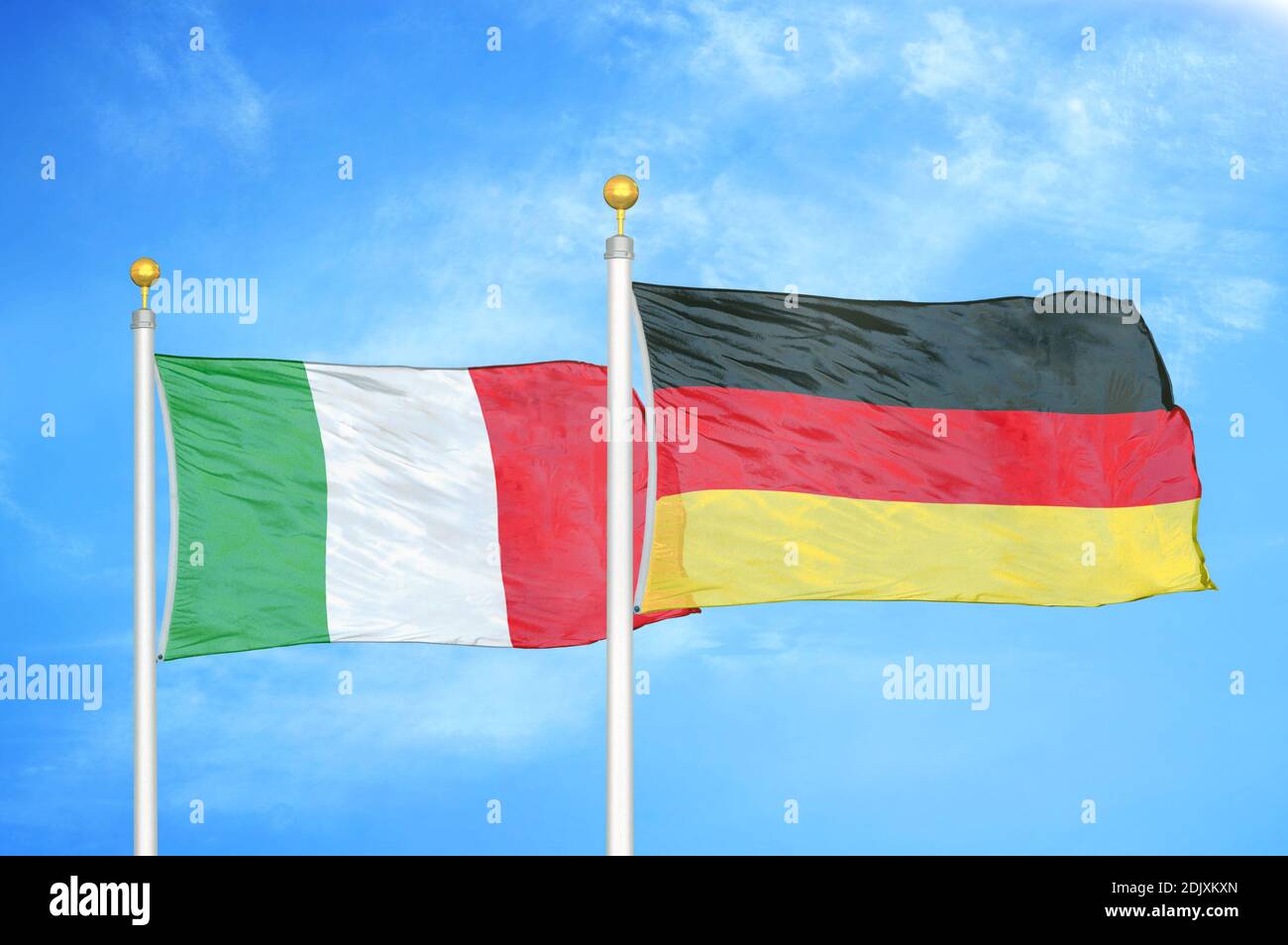 Italy and Germany two flags on flagpoles and blue cloudy sky Stock ...