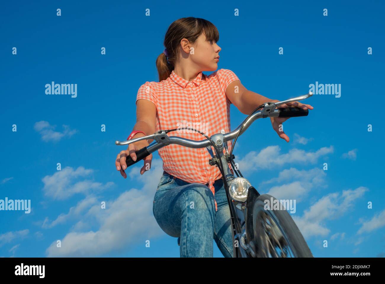 Girl riding bicycle low angle hi-res stock photography and images - Alamy
