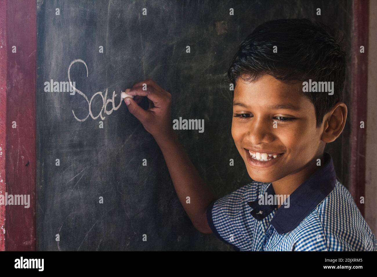 Asian boy writing on blackboard hi-res stock photography and images - Alamy