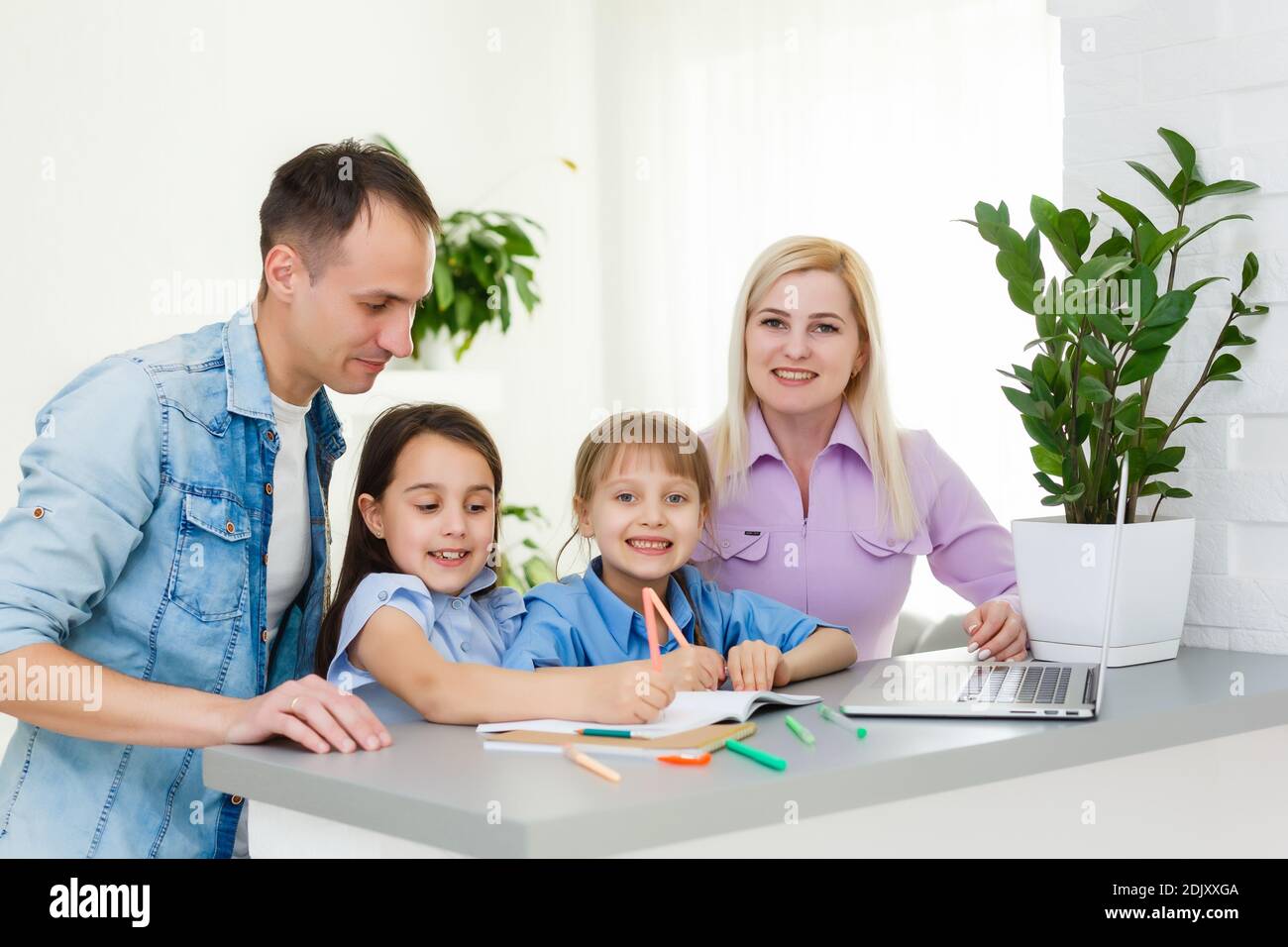 Family using the internet in the kitchen together Stock Photo - Alamy
