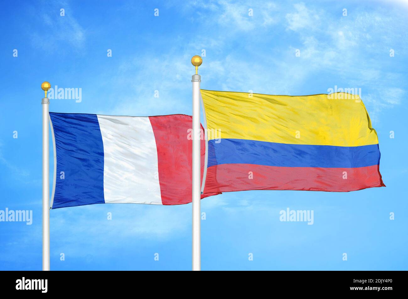 France and Colombia two flags on flagpoles and blue cloudy sky Stock ...