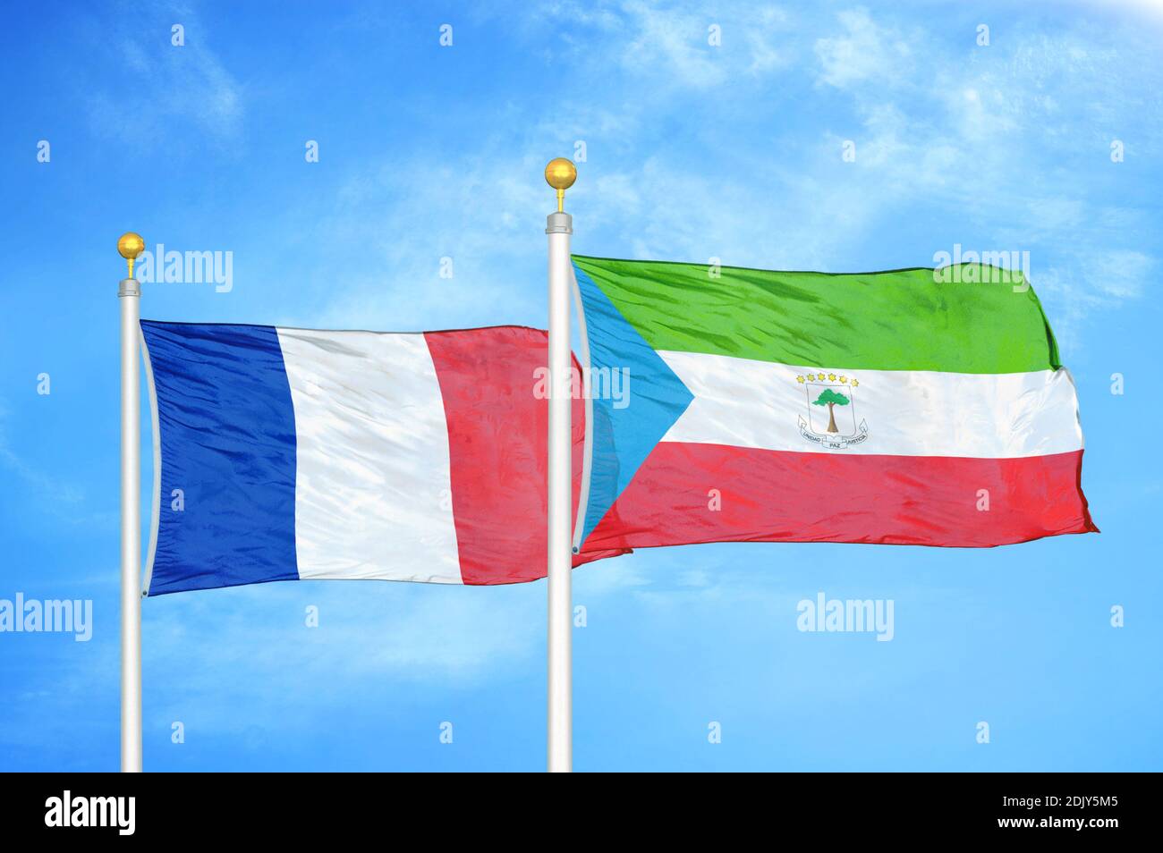 France and Equatorial Guinea two flags on flagpoles and blue cloudy sky ...