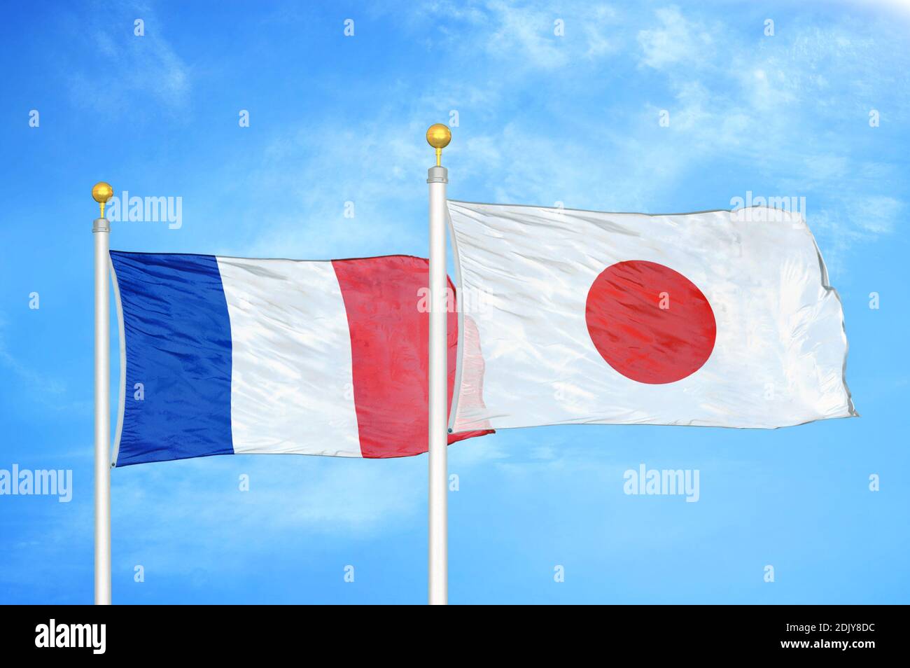 France and Japan two flags on flagpoles and blue cloudy sky Stock Photo ...