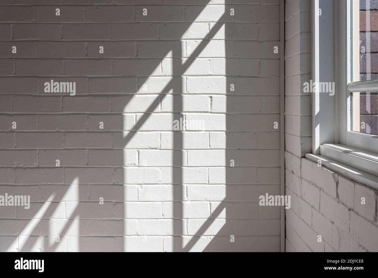 Sunlight And Hard Shadows From Window Against White Brick Wall In ...
