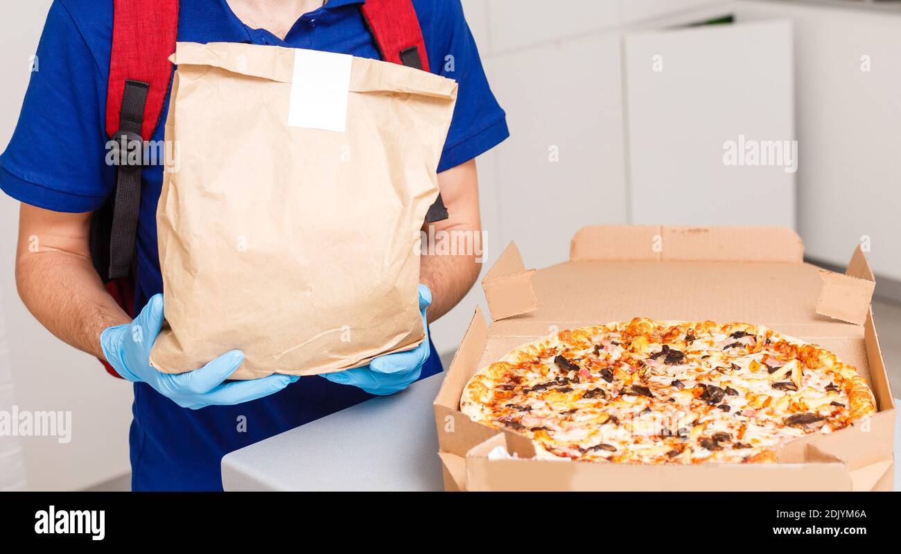 Diverse of paper containers for takeaway food. Delivery man is carrying ...