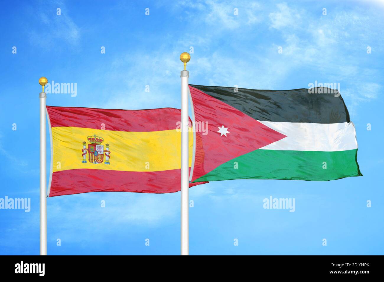 Spain and Jordan two flags on flagpoles and blue cloudy sky Stock Photo ...