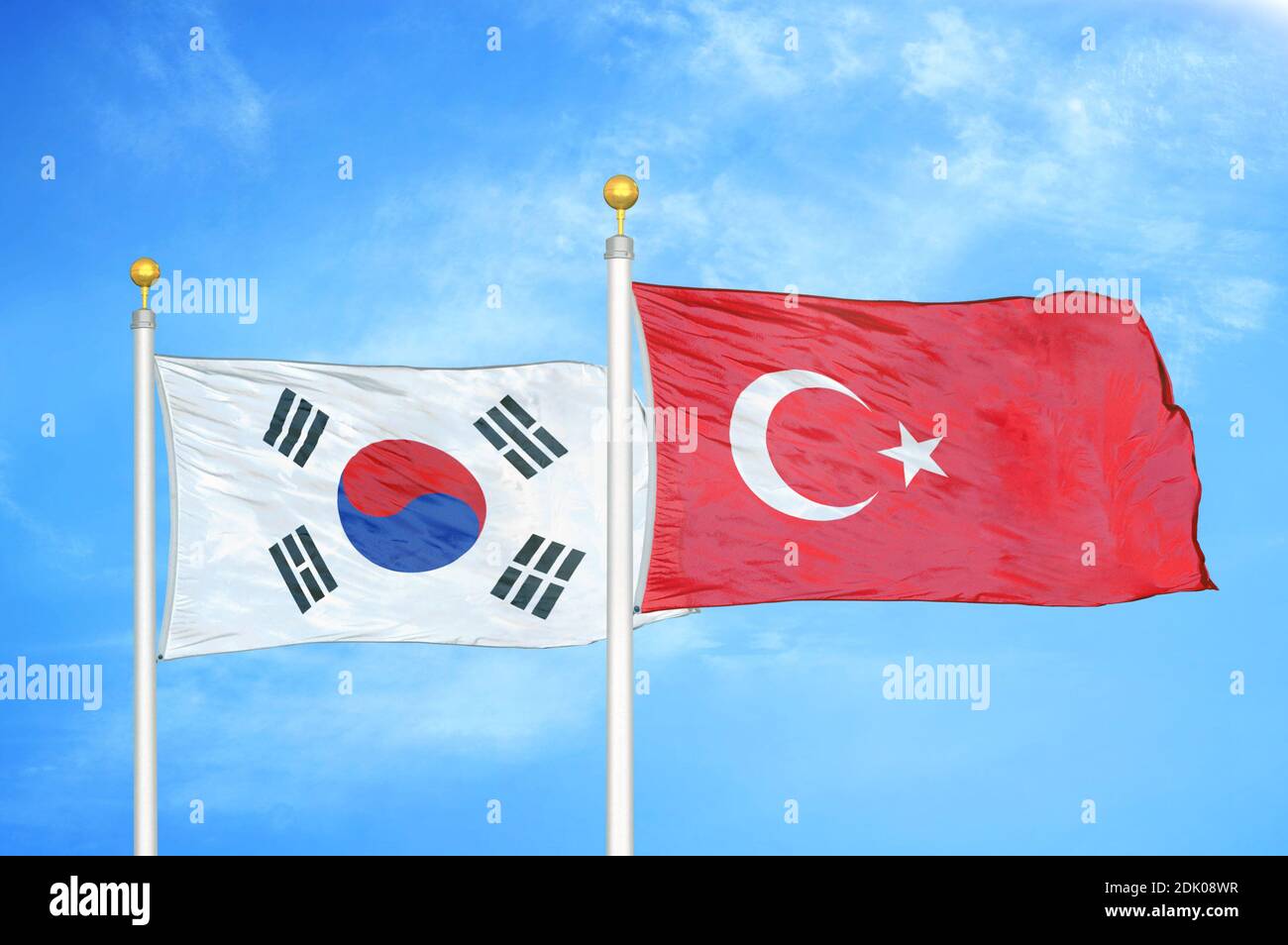 South Korea and Turkey two flags on flagpoles and blue cloudy sky Stock ...