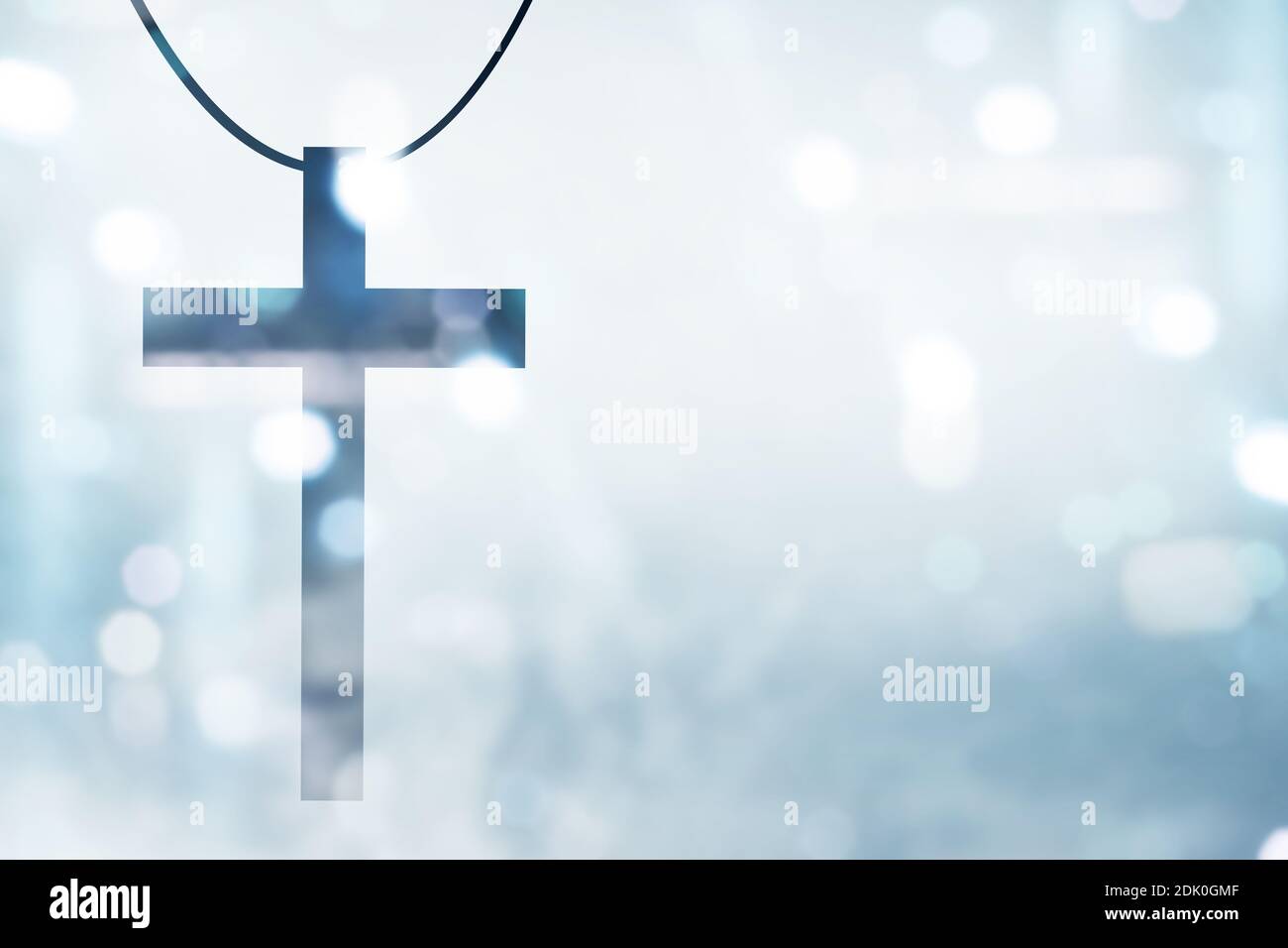 Christian cross with blurred light background Stock Photo - Alamy