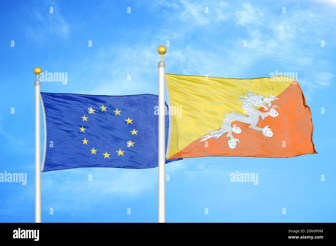 European Union and Bhutan two flags on flagpoles and blue cloudy sky ...