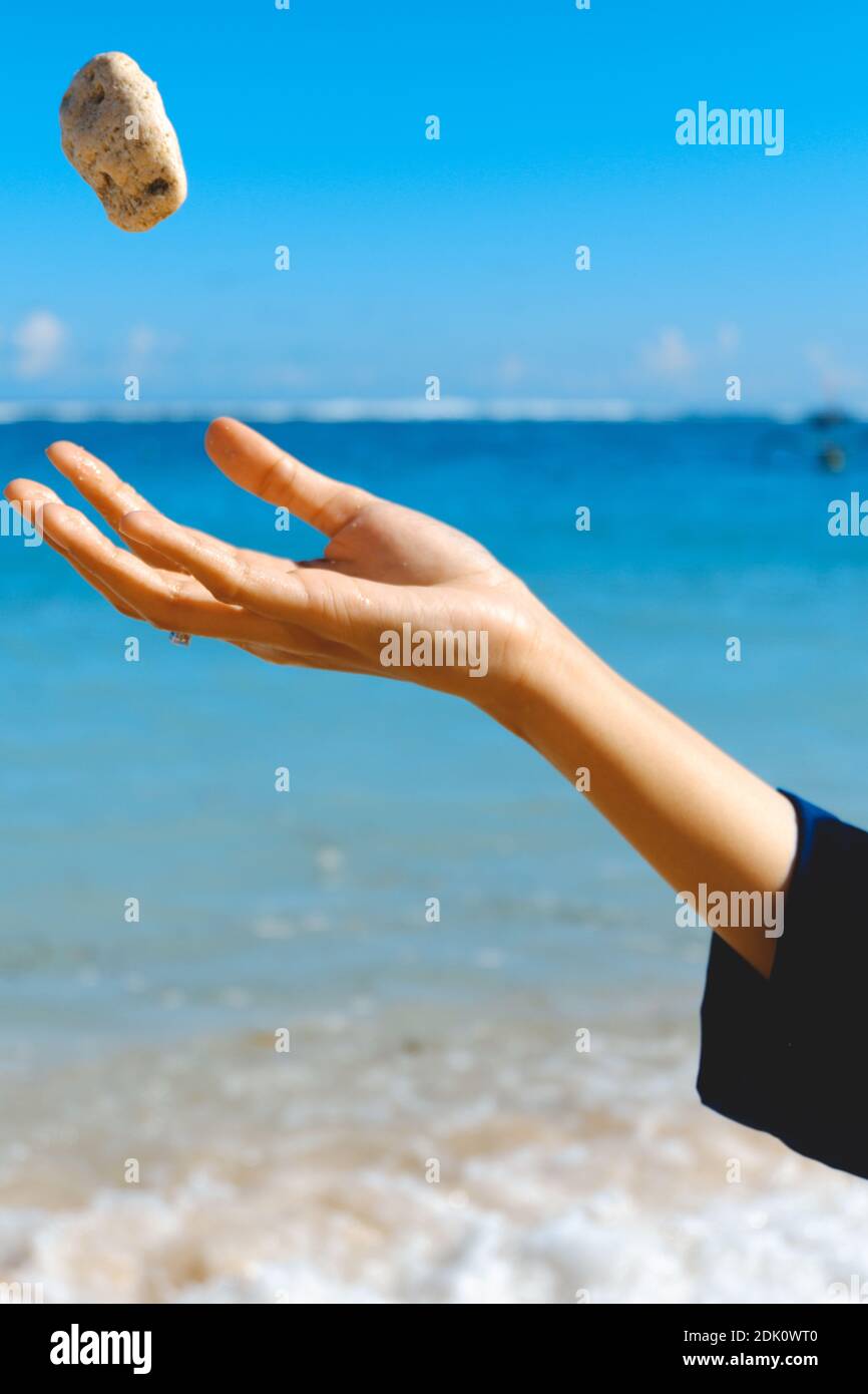 Woman throwing stone sea hi-res stock photography and images - Alamy