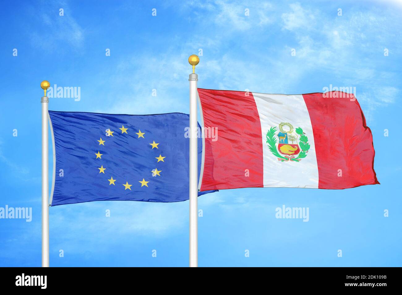 European Union and Peru two flags on flagpoles and blue cloudy sky ...