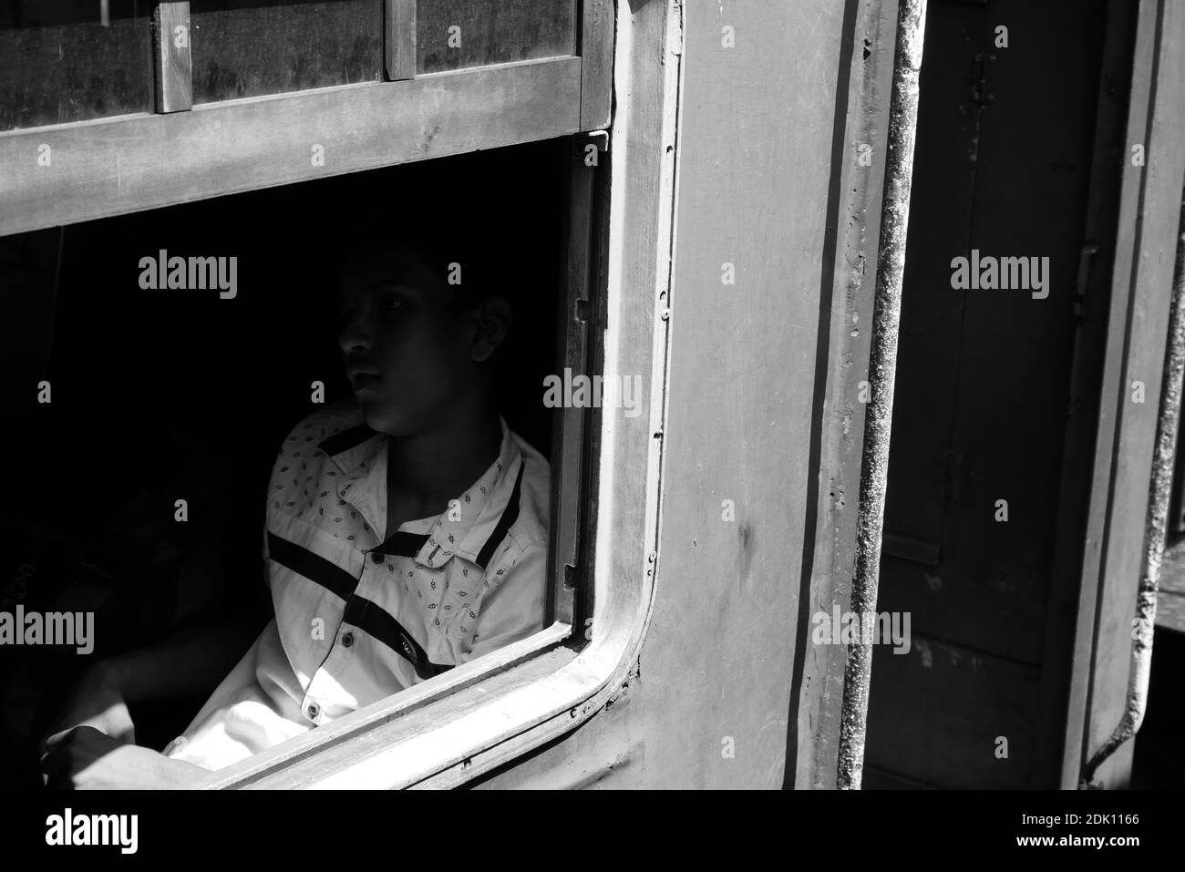 Man looking through train window Black and White Stock Photos & Images ...