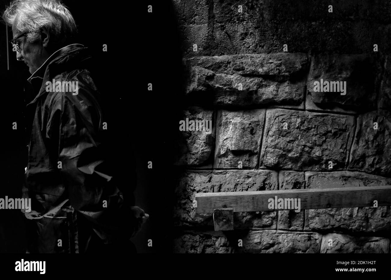 Side View Of Mature Man Standing Against Wall At Night Stock Photo - Alamy