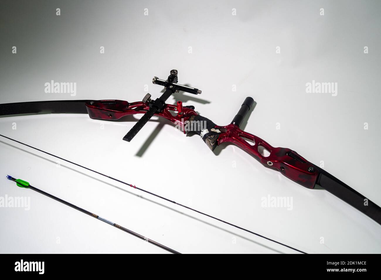 A high ang of a bow with a single arrow on a white surface Stock Photo ...