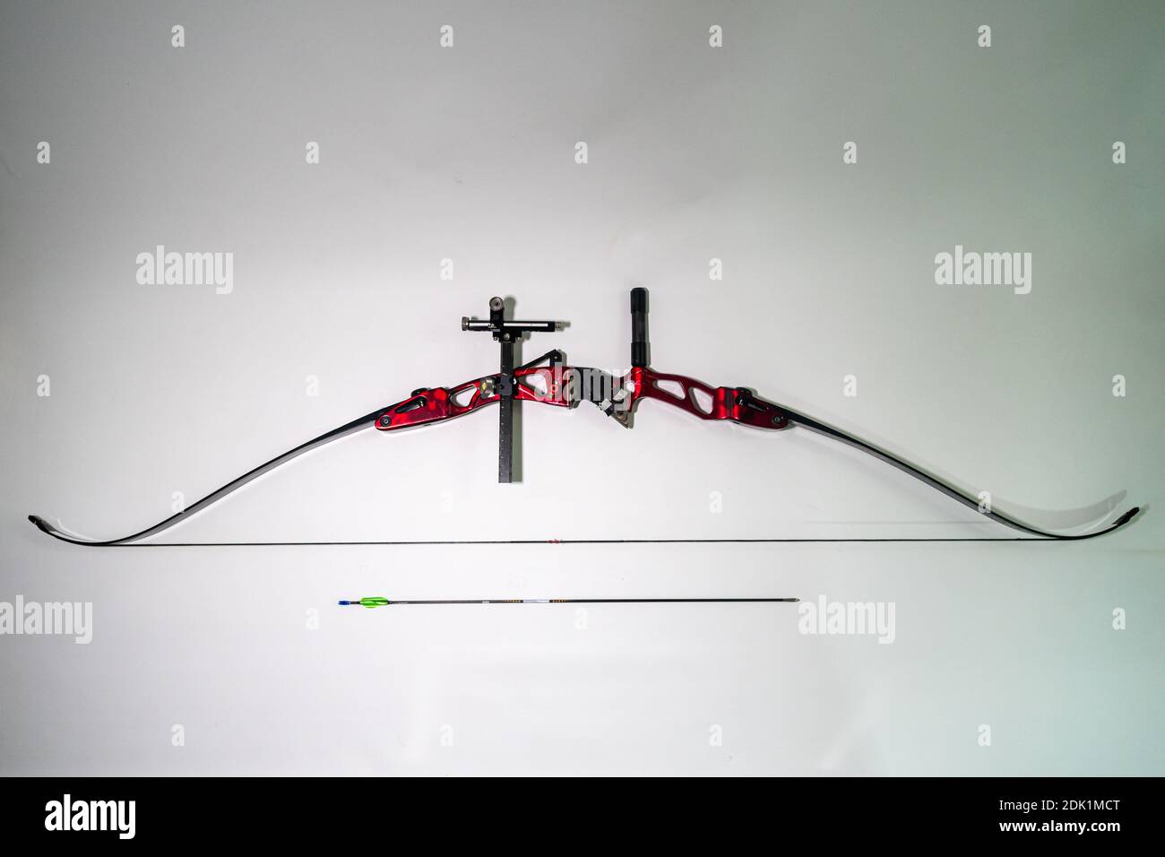 A top view of a bow with a single arrow placed on a white surface Stock ...