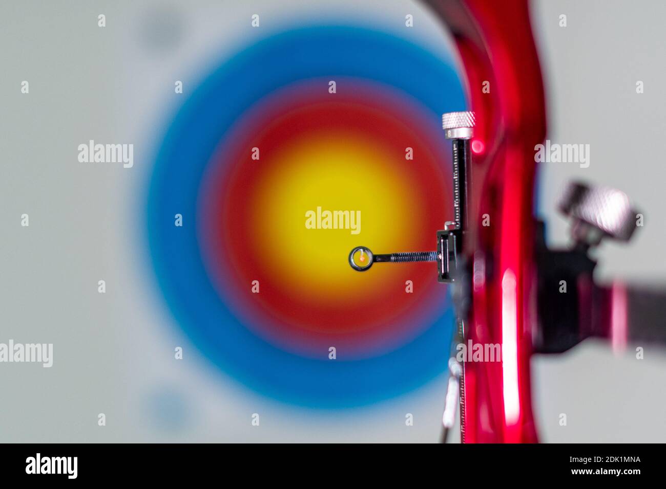 A selective focus shot of a bow and arrow pointing the center of a ...