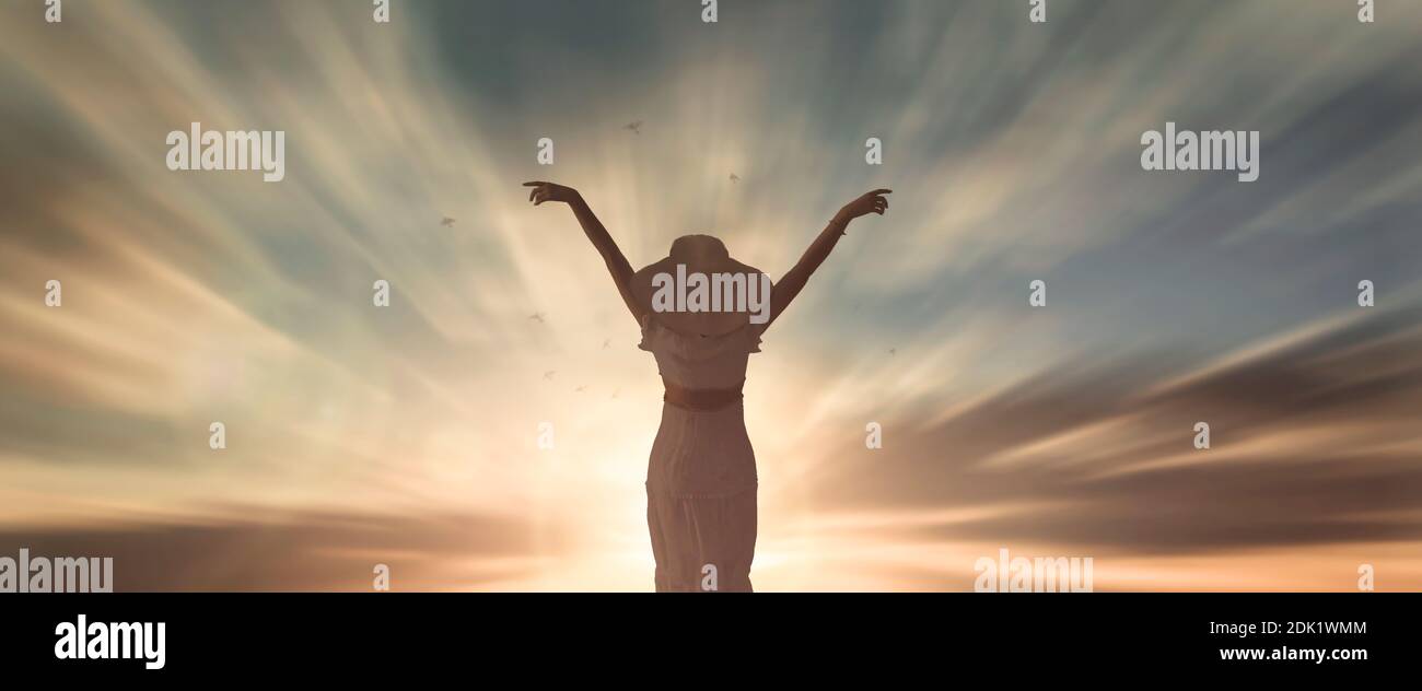 Silhouette woman with hands rise up on beautiful view. Christian praise ...