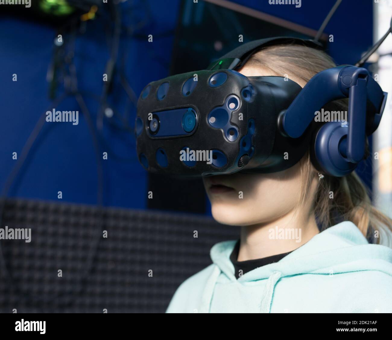 Young teen girl wearing virtual reality goggles. VR headset. Futuristic ...