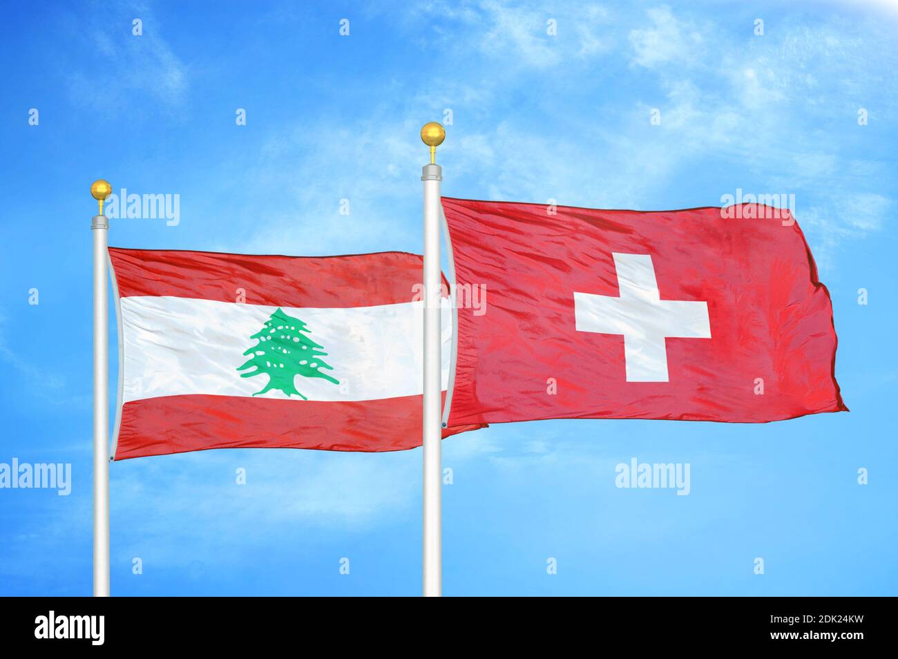 Lebanon and Switzerland two flags on flagpoles and blue cloudy sky ...