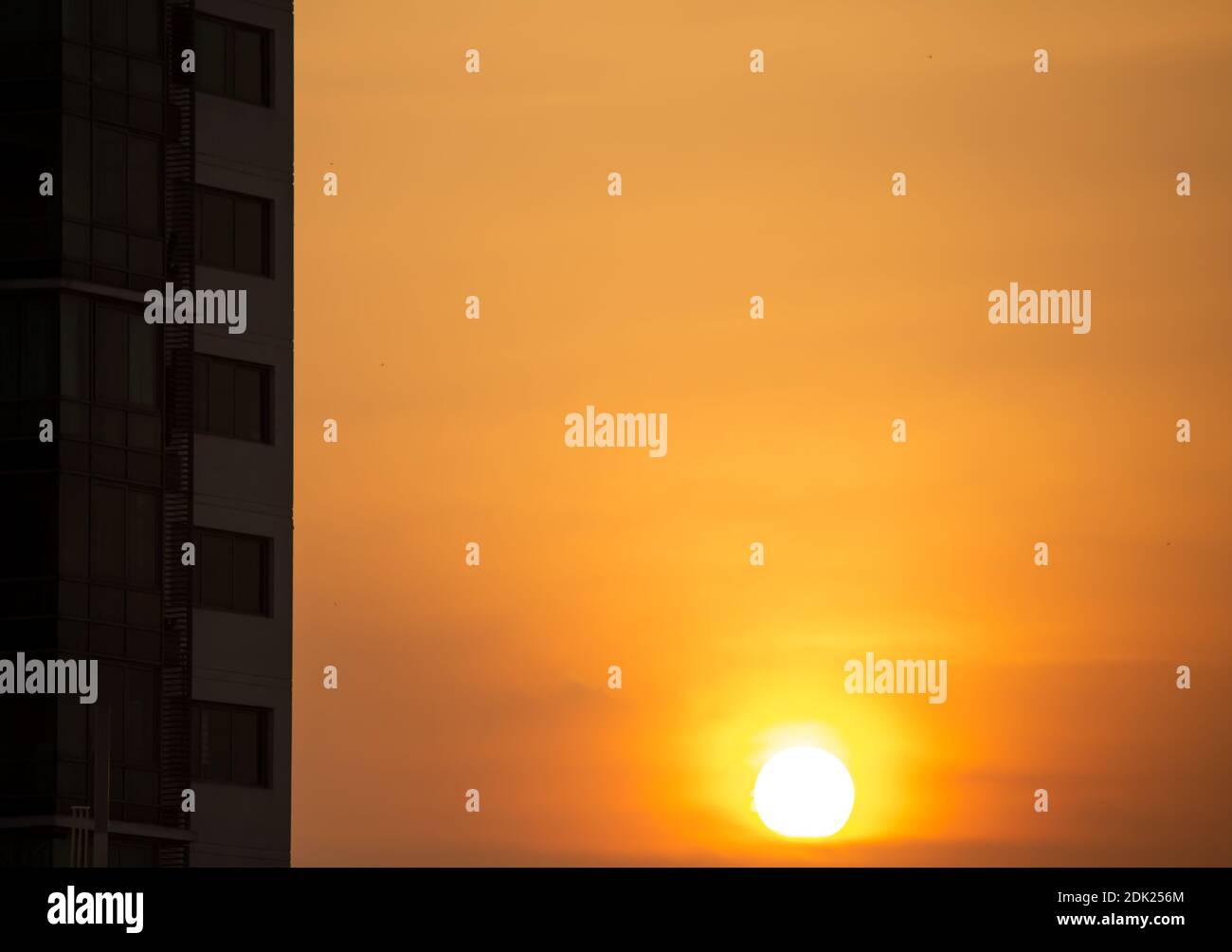 Beautiful view of the sunset in city with high-rise building alongside ...