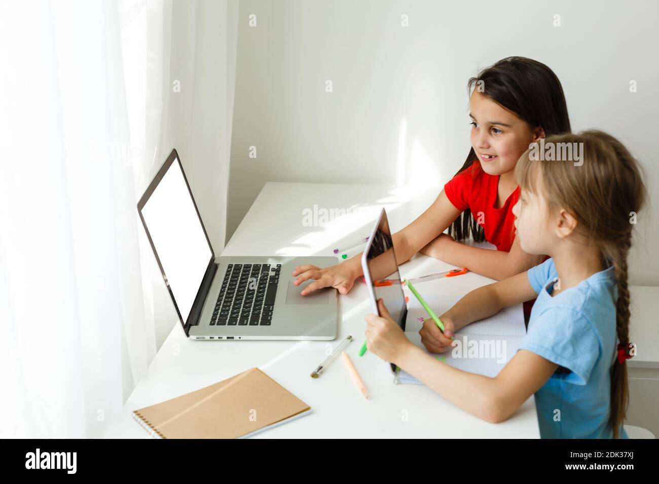 Cool online school. Kids studying online at home using a laptop ...