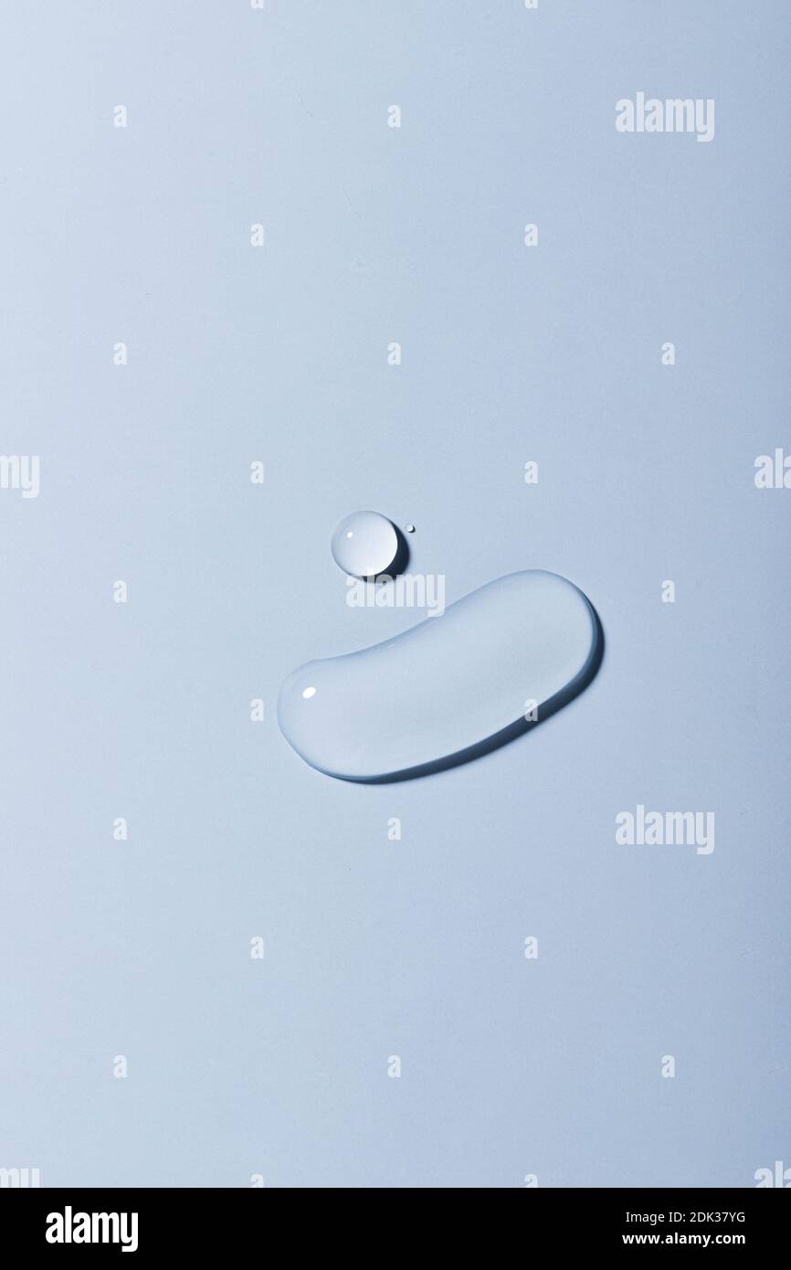 A top vie closeup of multiple waterdrops on a light blue background ...