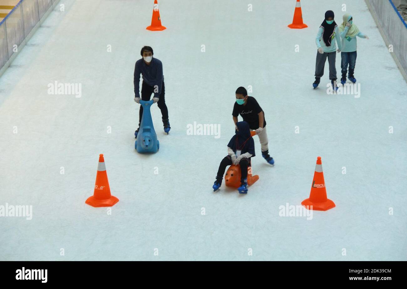 People play ice skating at a Grand City Mall in Surabaya, East Java ...